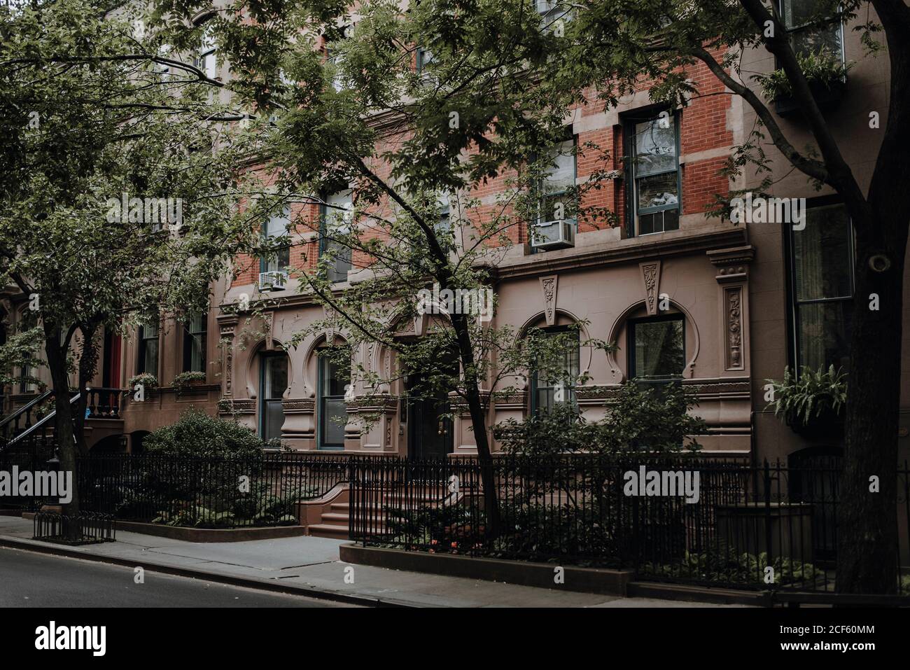 Exterior of aged stone building with red wall and ornamental elements ...