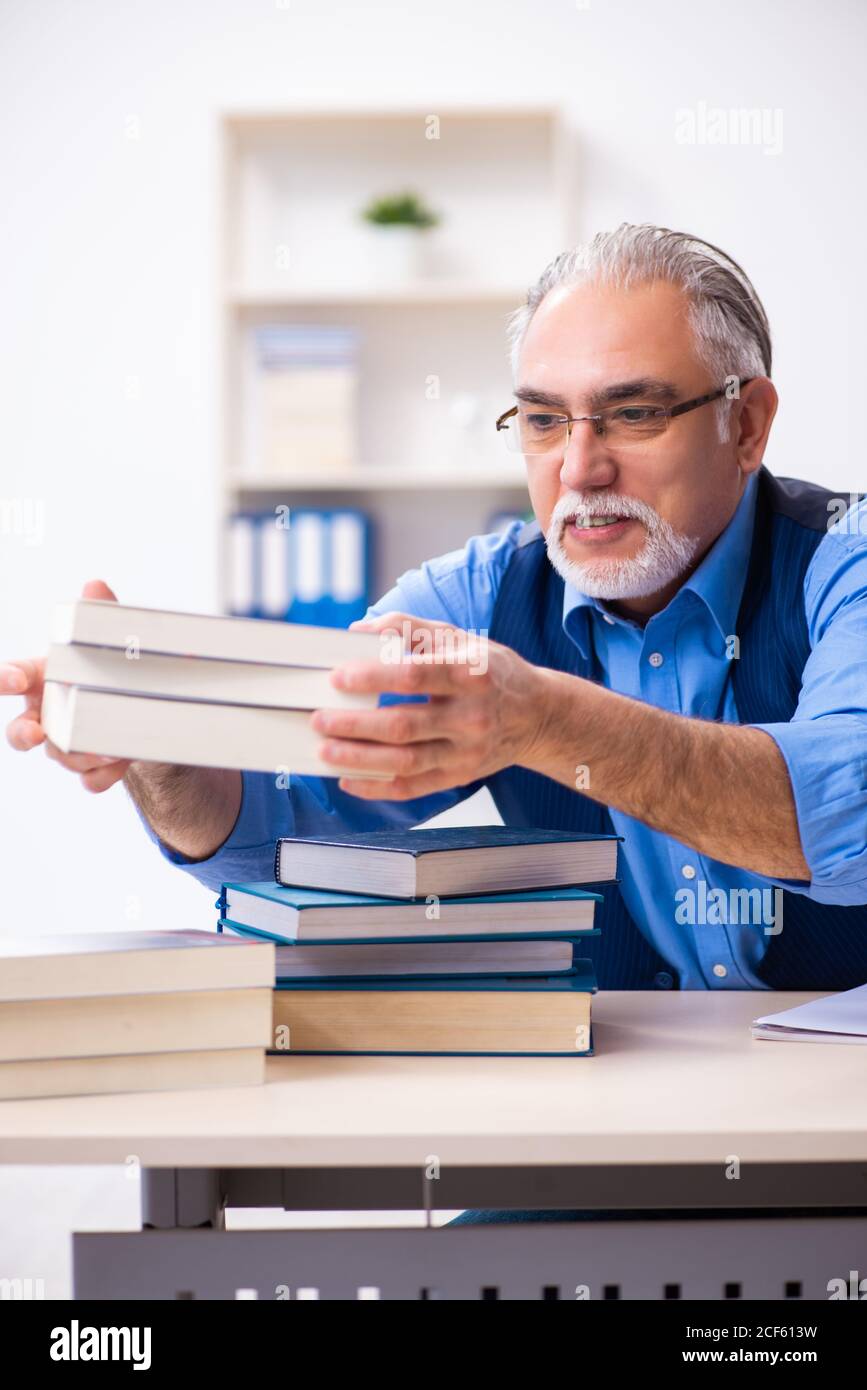 Old male author writing books at home Stock Photo - Alamy