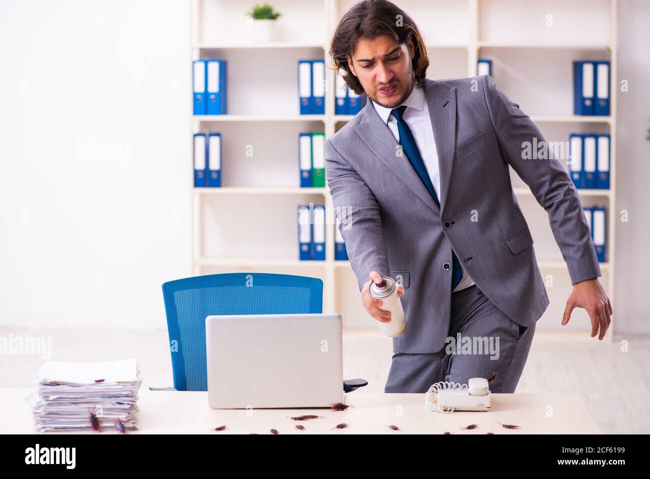 Young employee and too many cockroaches in the office Stock Photo - Alamy