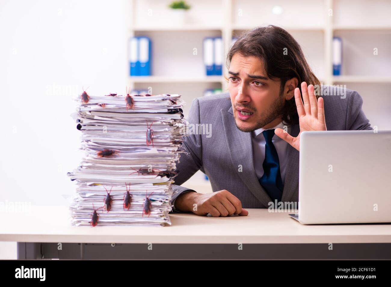 Young employee and too many cockroaches in the office Stock Photo - Alamy