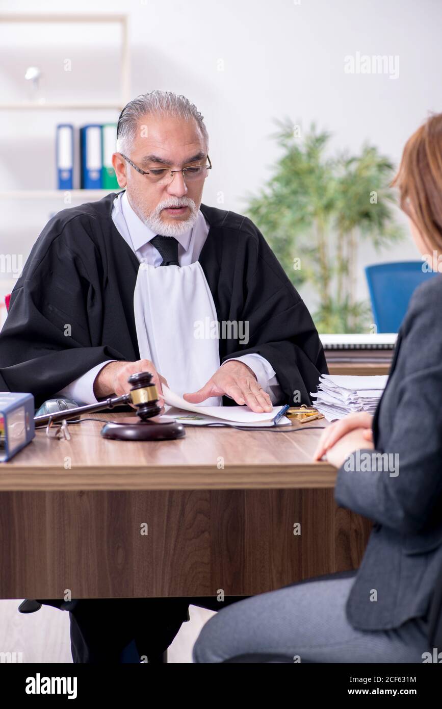Old judge and female client in the office Stock Photo - Alamy