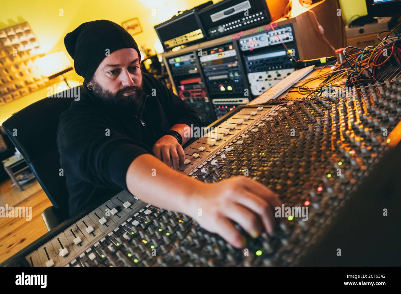 man musician working while playing in a equalizer instrument in a ...