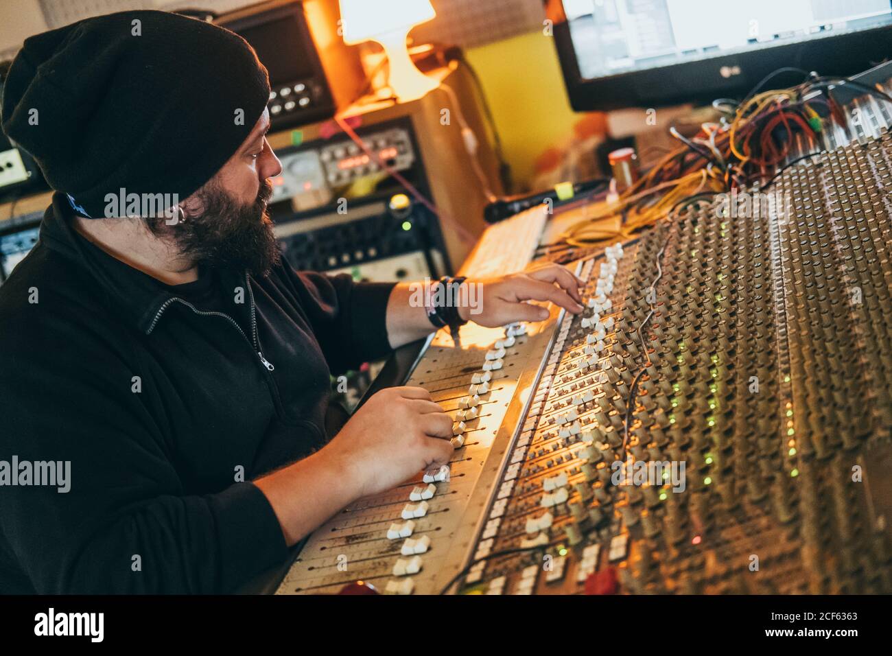 man musician working while playing in a equalizer instrument in a ...