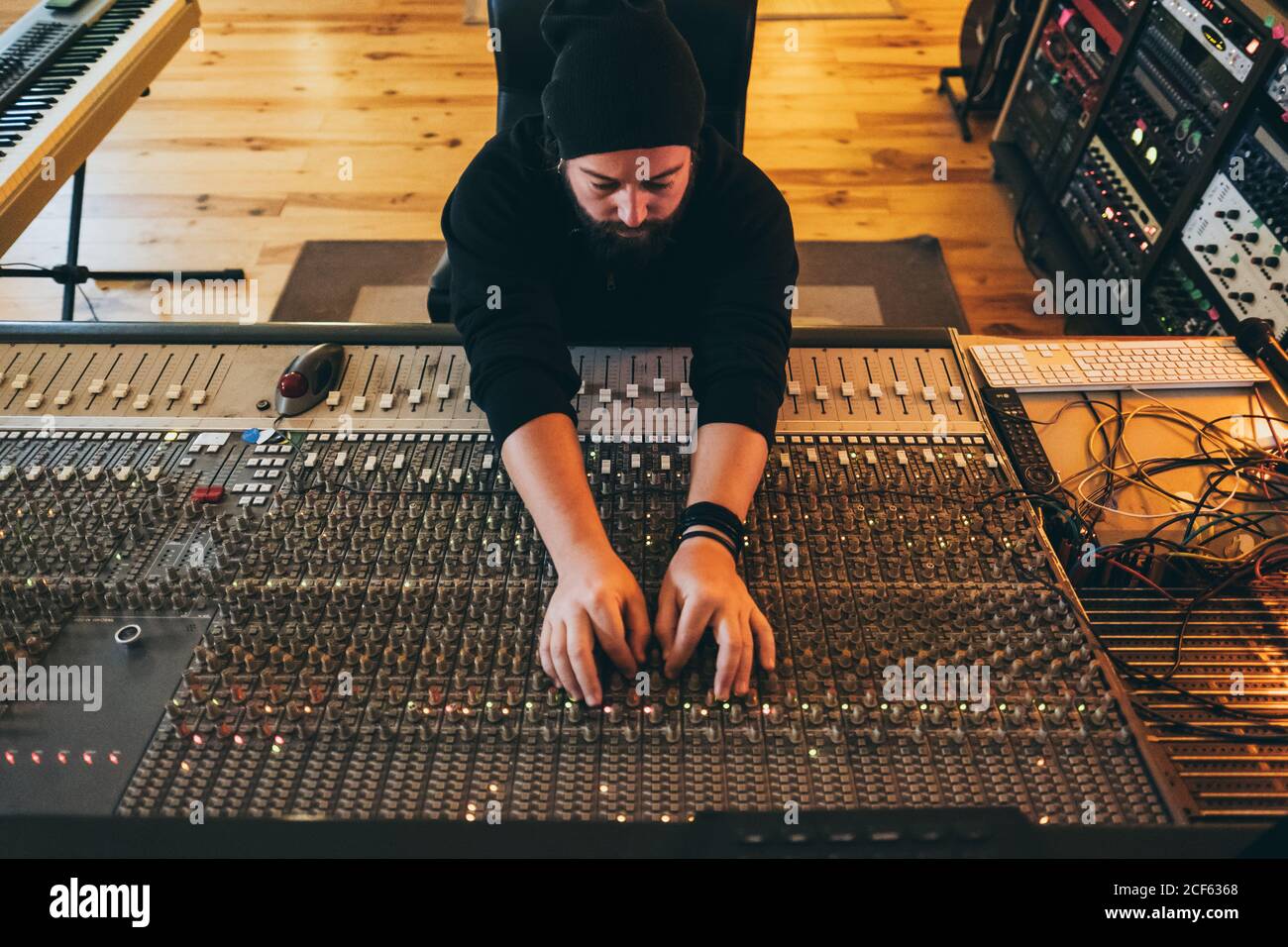 man musician working while playing in a equalizer instrument in a ...