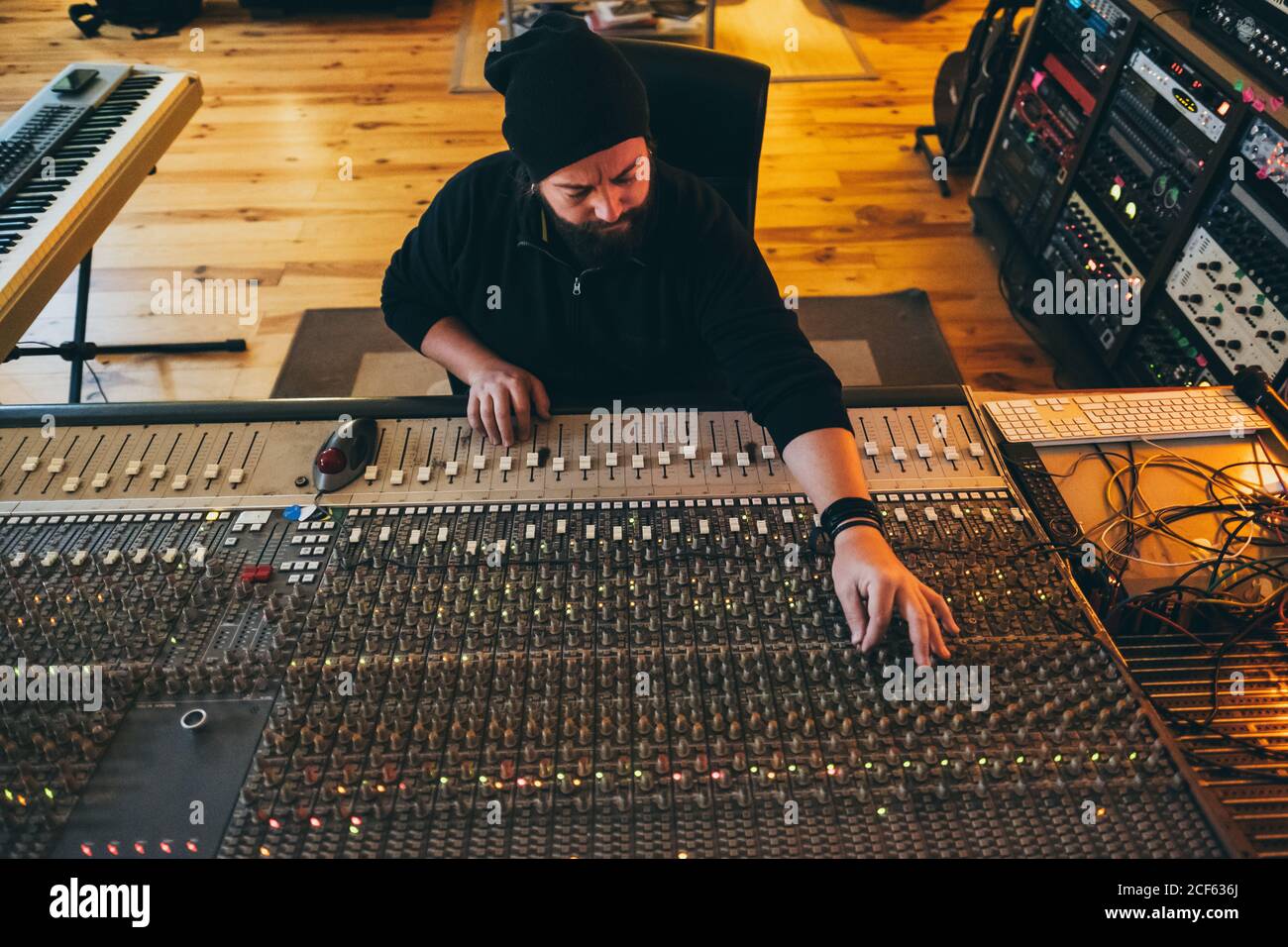 man musician working while playing in a equalizer instrument in a ...