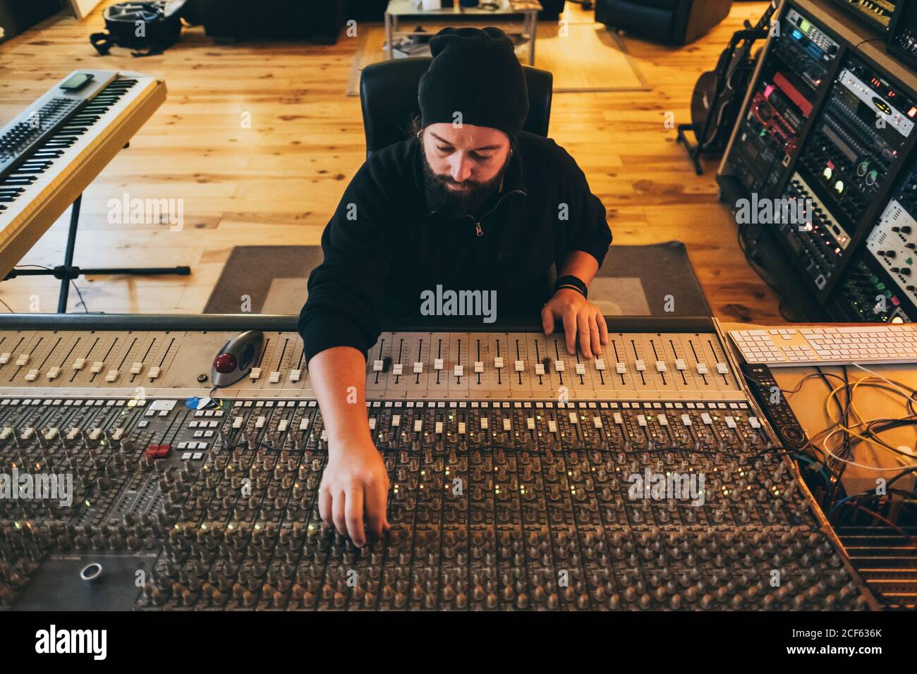 man musician working while playing in a equalizer instrument in a ...