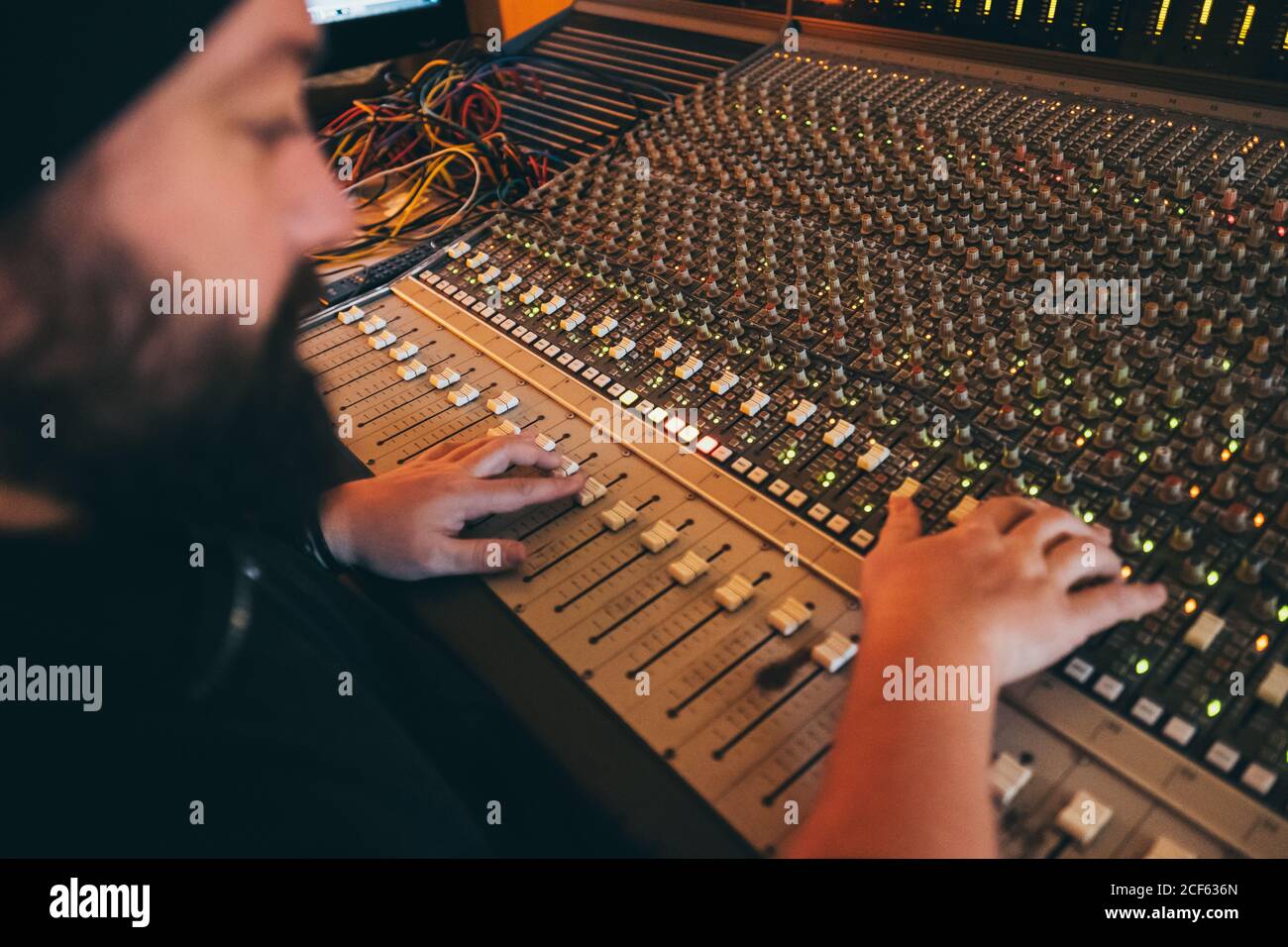 man musician working while playing in a equalizer instrument in a ...