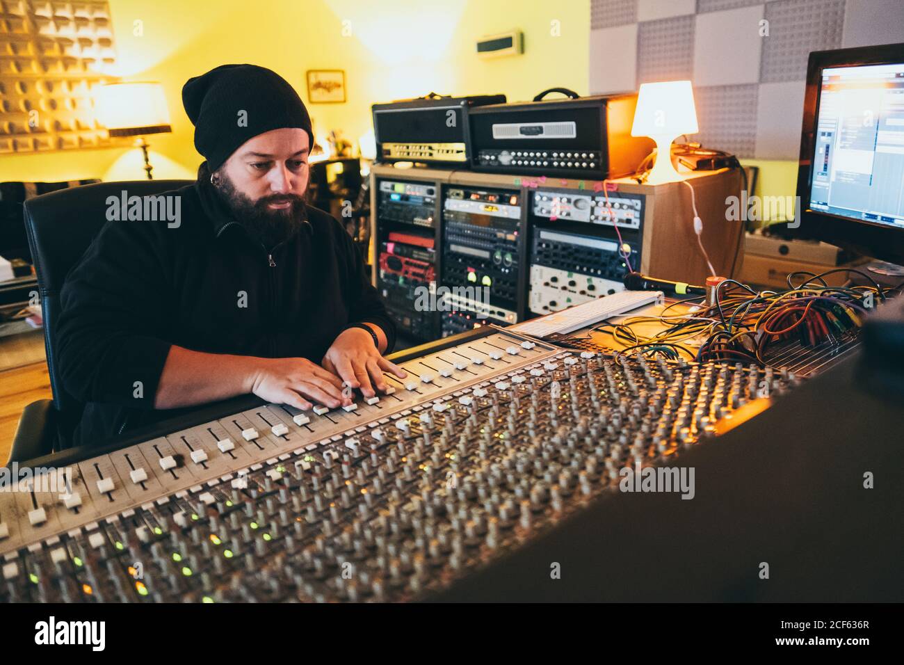 man musician working while playing in a equalizer instrument in a ...
