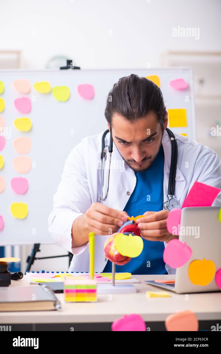 Young medic in conflicting priorities concept Stock Photo - Alamy