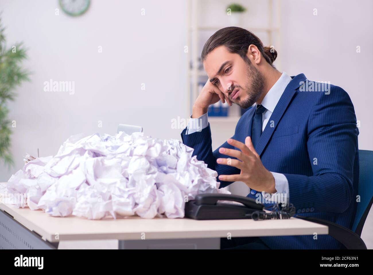 Businessman rejecting ideas with lots of papers Stock Photo - Alamy