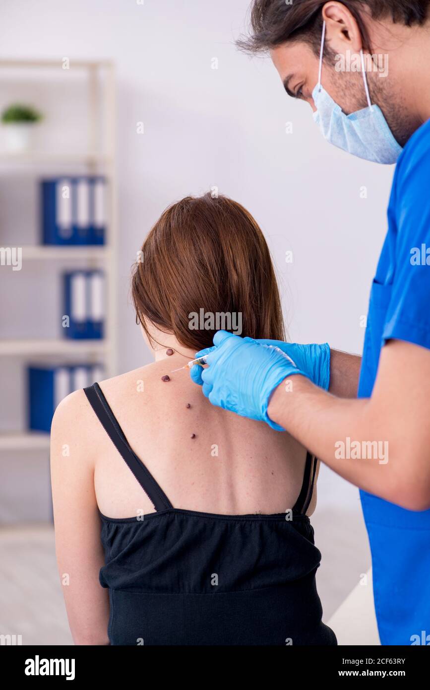 Young woman visiting doctor dermatologist Stock Photo - Alamy
