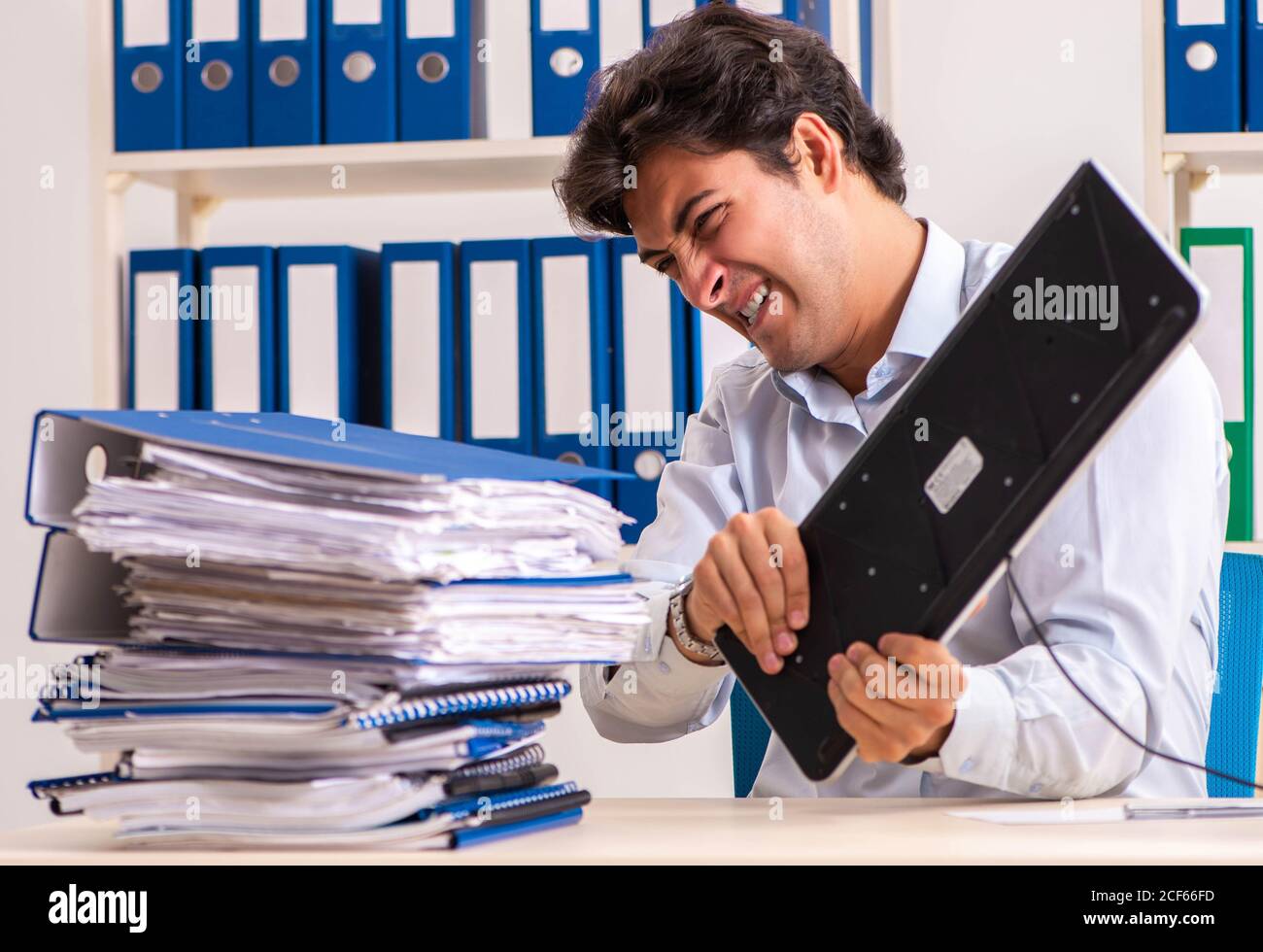 The overloaded busy employee with too much work and paperwork Stock ...