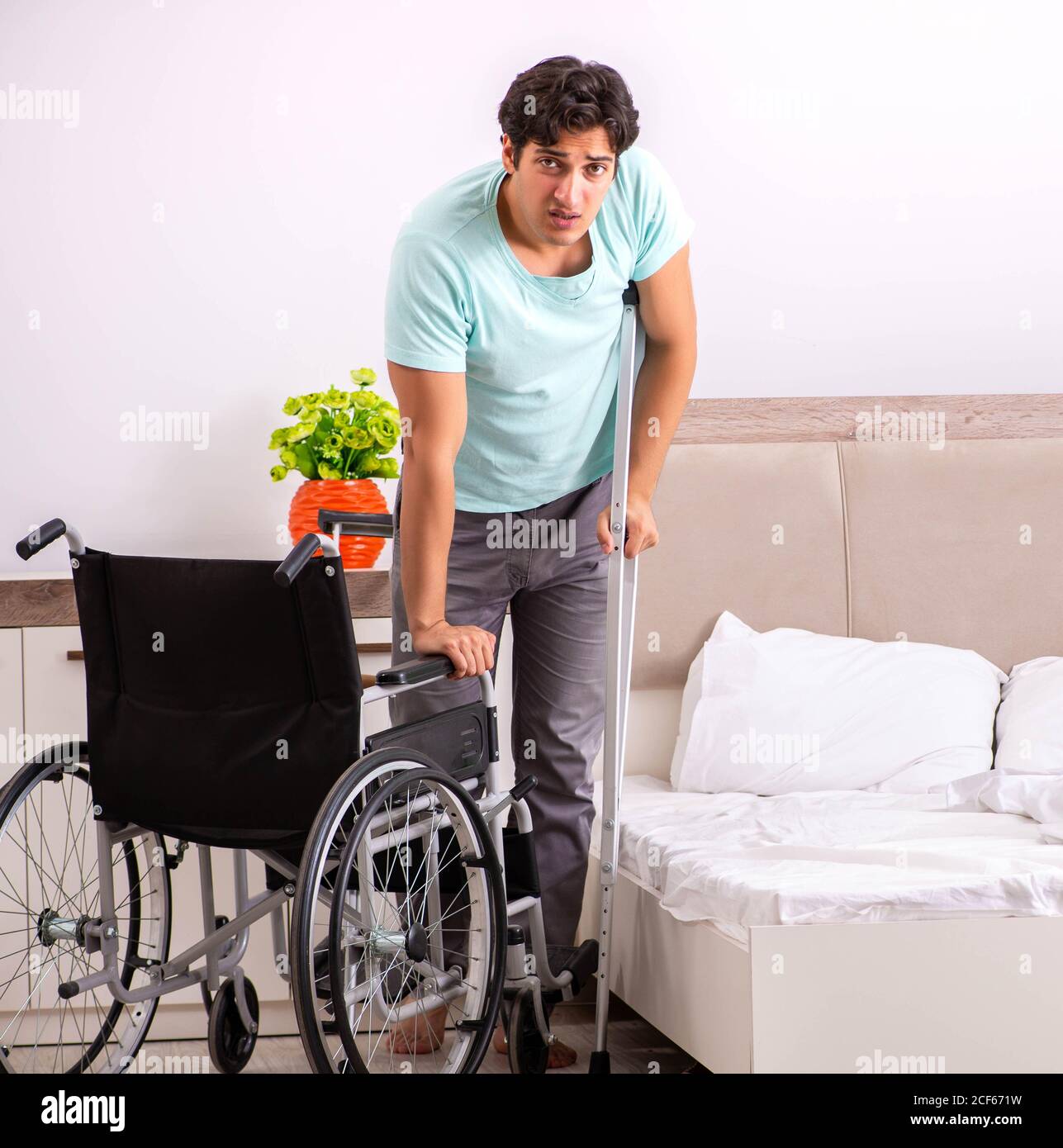 The young handsome disabled man recovering at home Stock Photo - Alamy