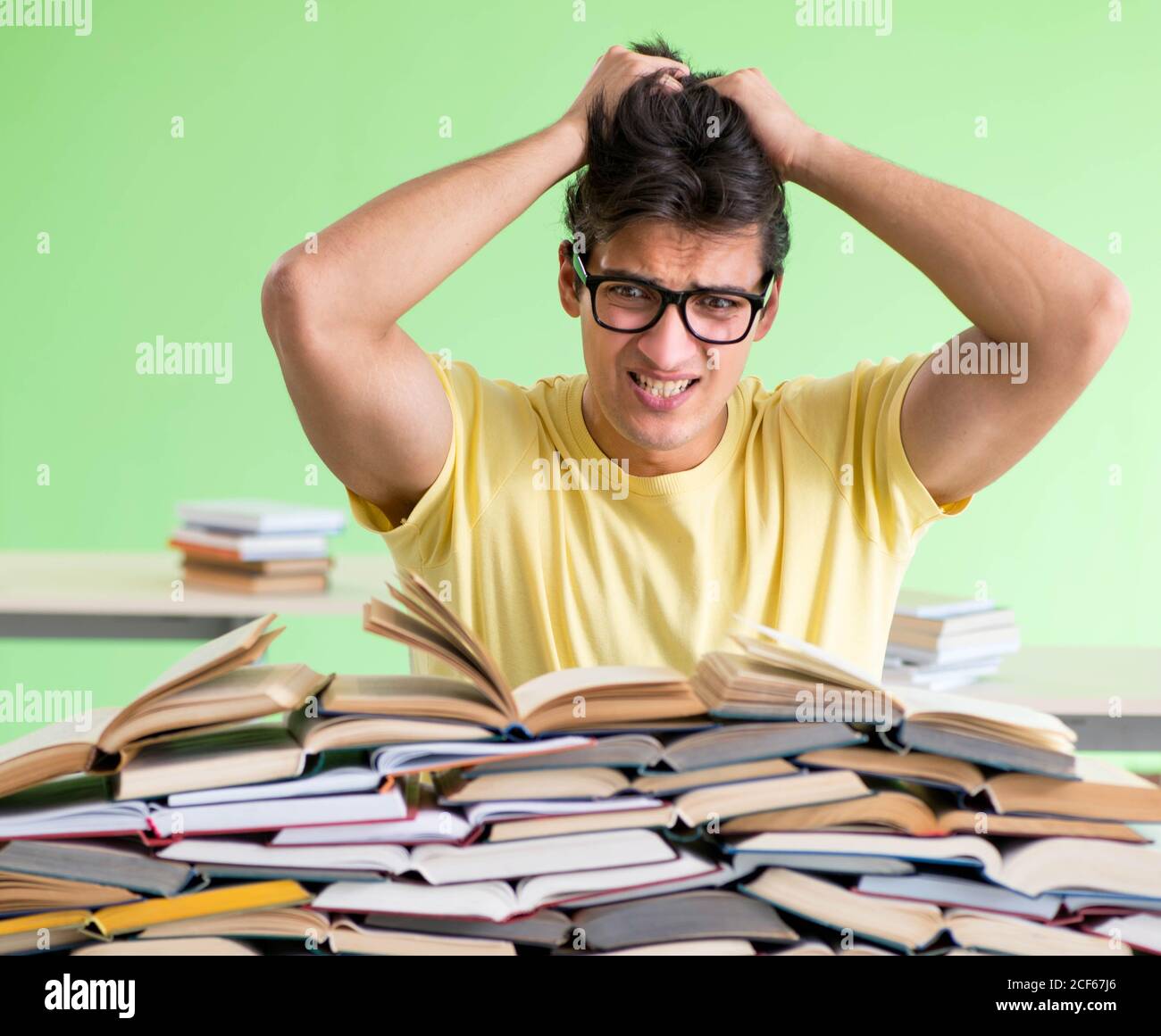 The student with too many books to read before exam Stock Photo - Alamy
