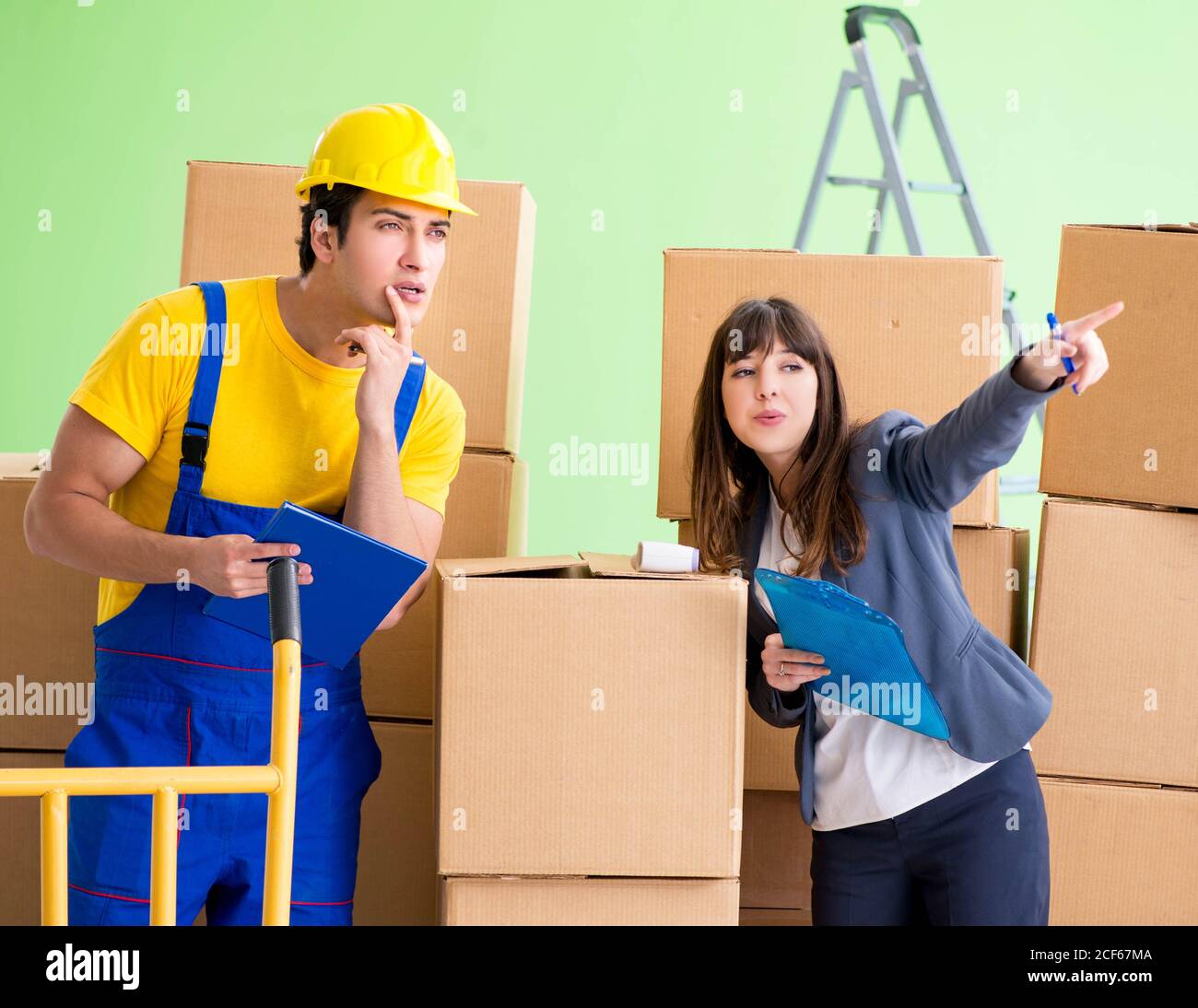 The woman boss and man contractor working with boxes delivery Stock ...