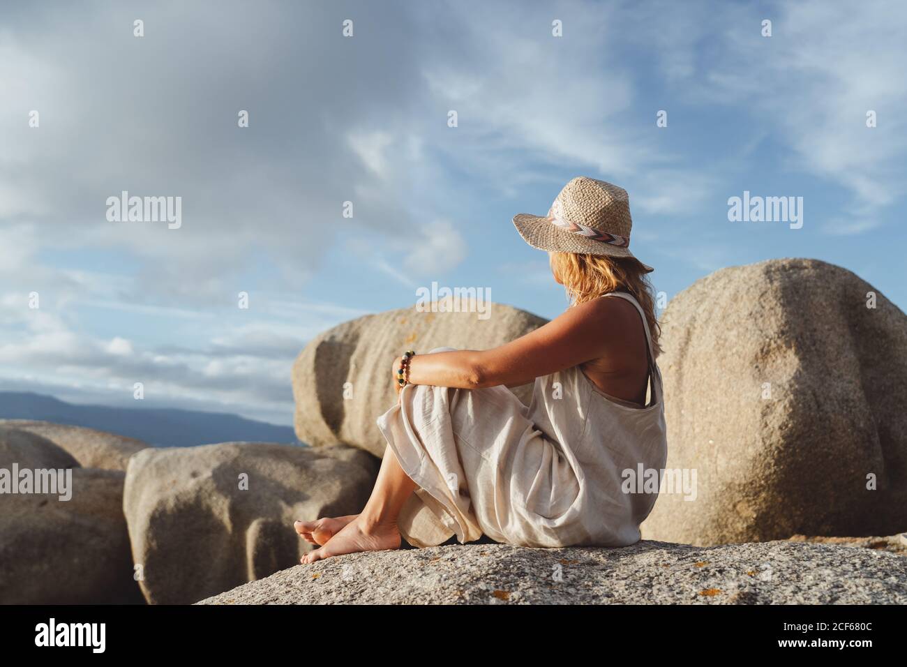 Pair of gloves near pick axe and hoe with wooden handles on rough ...