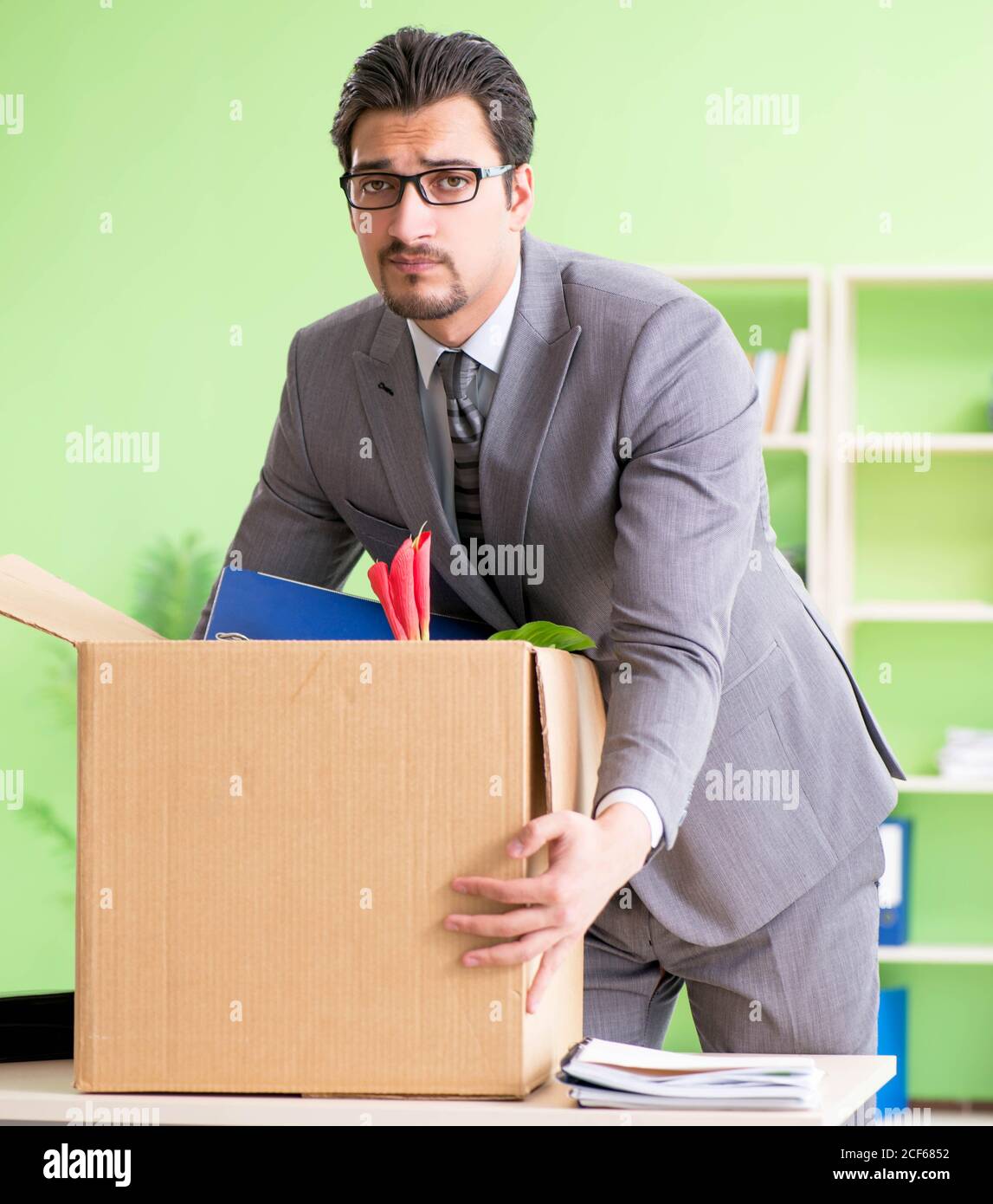 The male employee collecting his stuff after redundancy Stock Photo - Alamy