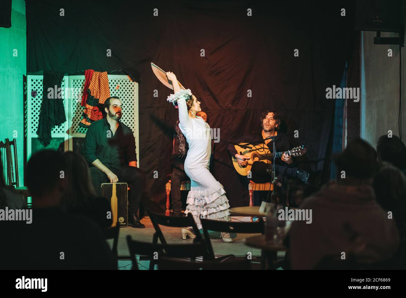 Trio of Hispanic artists giving flamenco performance on theater stage ...