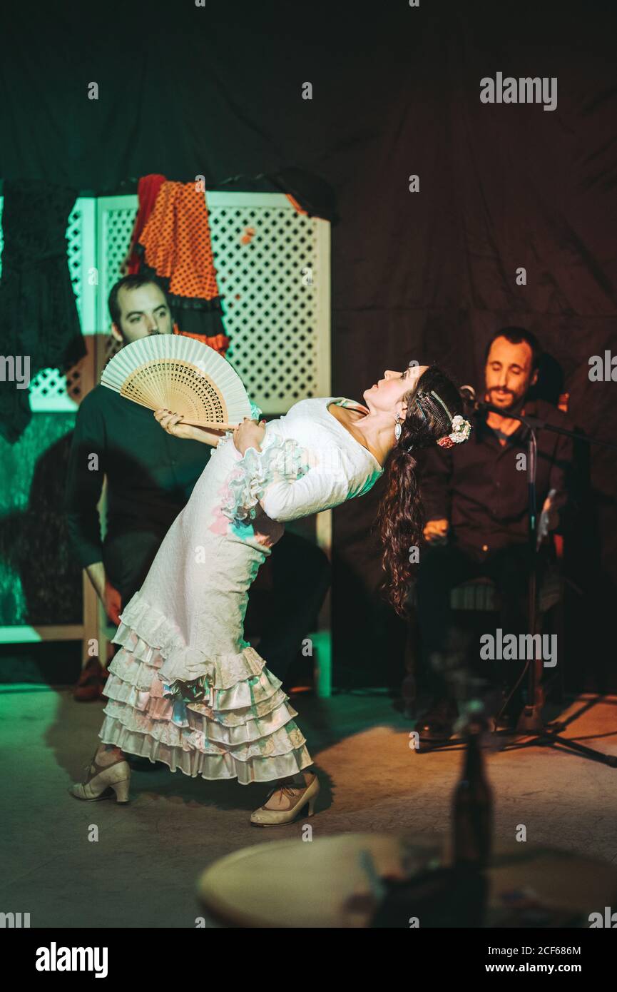 Trio of Hispanic artists giving flamenco performance on theater stage ...