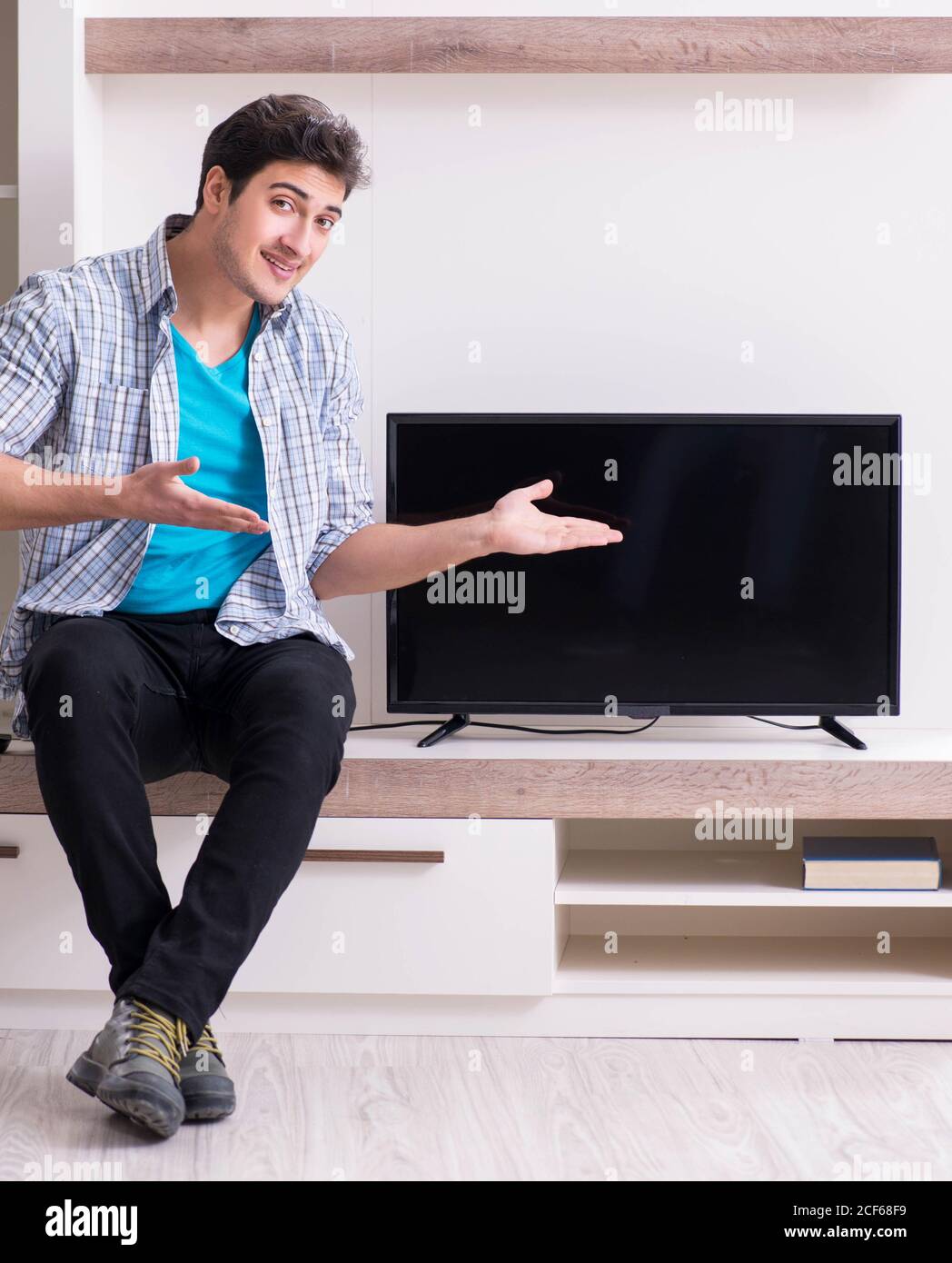 The young man watching tv at home Stock Photo - Alamy