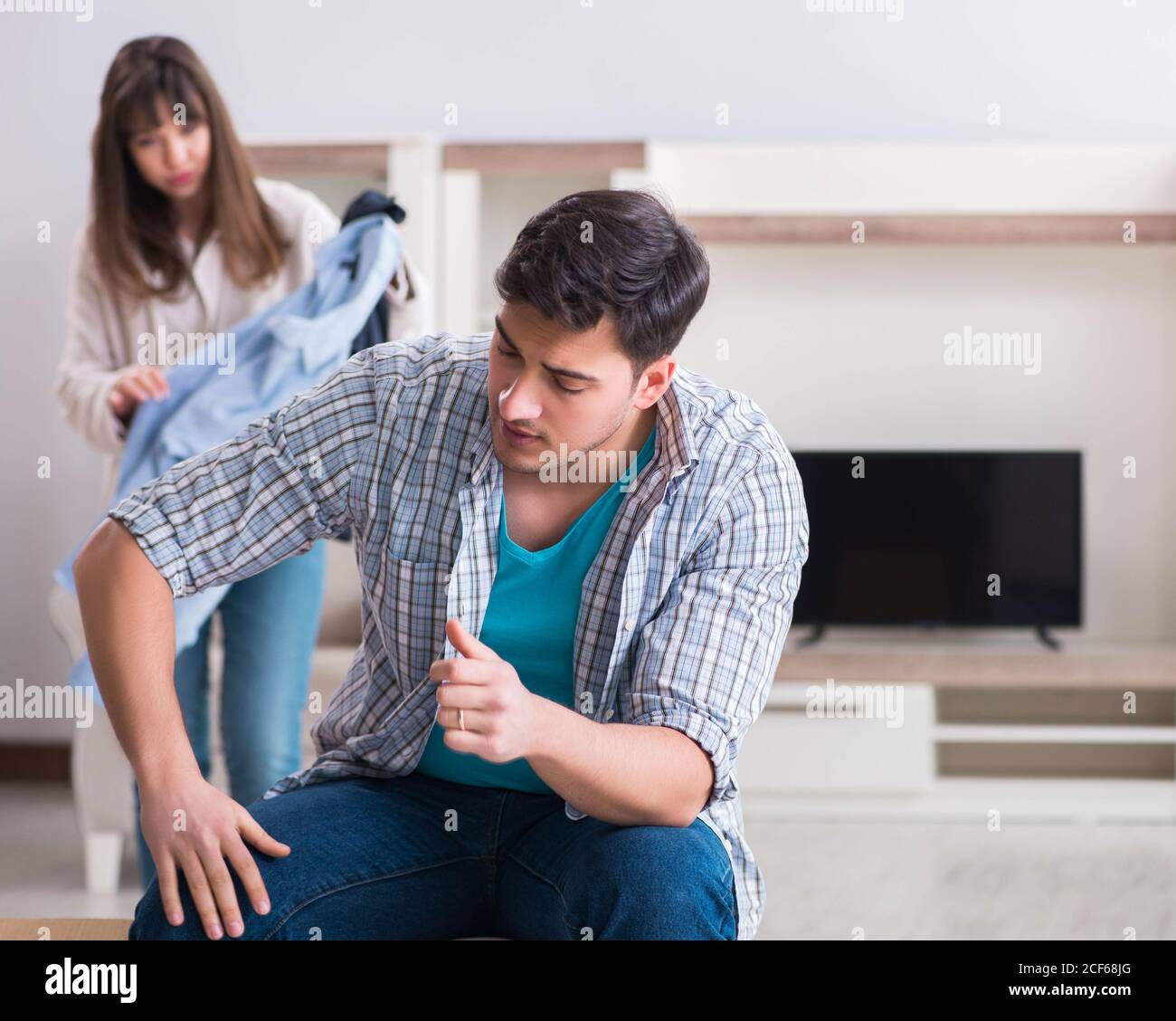 The woman evicting man from house during family conflict Stock Photo ...