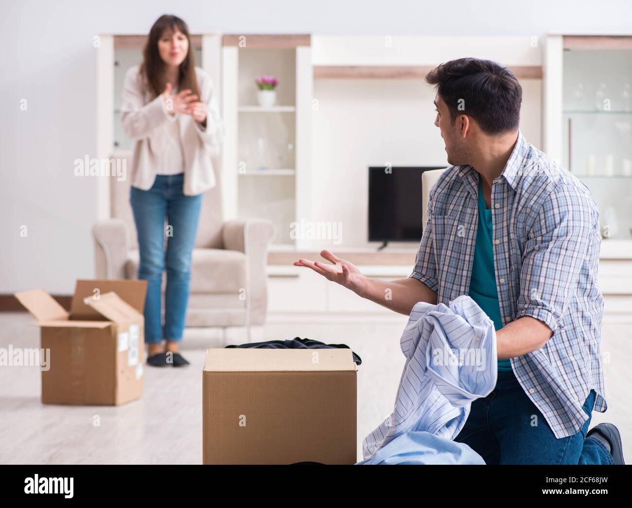 The woman evicting man from house during family conflict Stock Photo ...