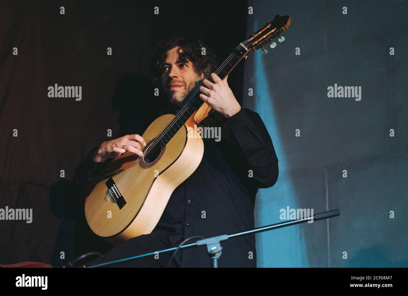 Hispanic guitarist giving performance on theater stage Stock Photo - Alamy