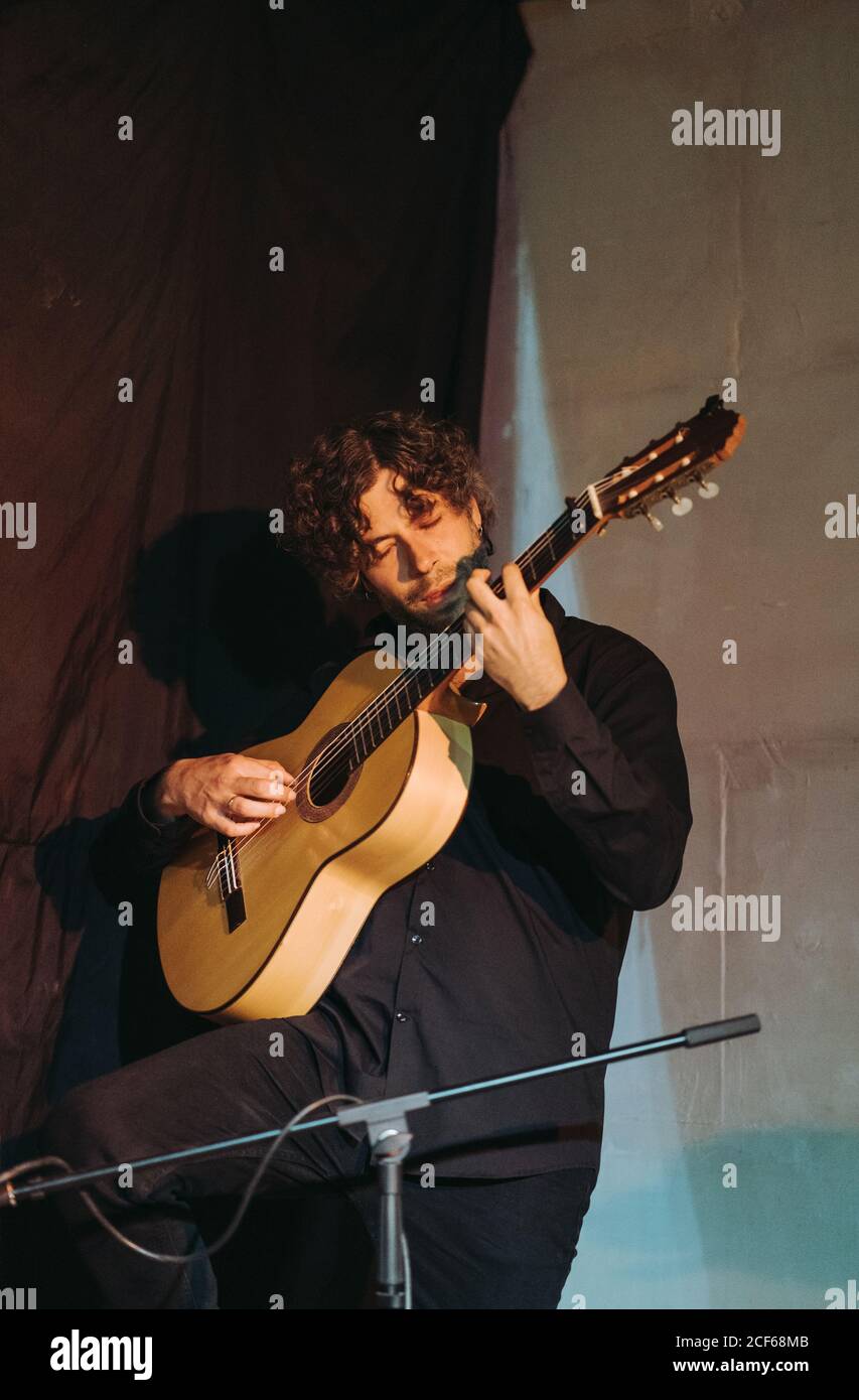 Hispanic guitarist giving performance on theater stage Stock Photo - Alamy