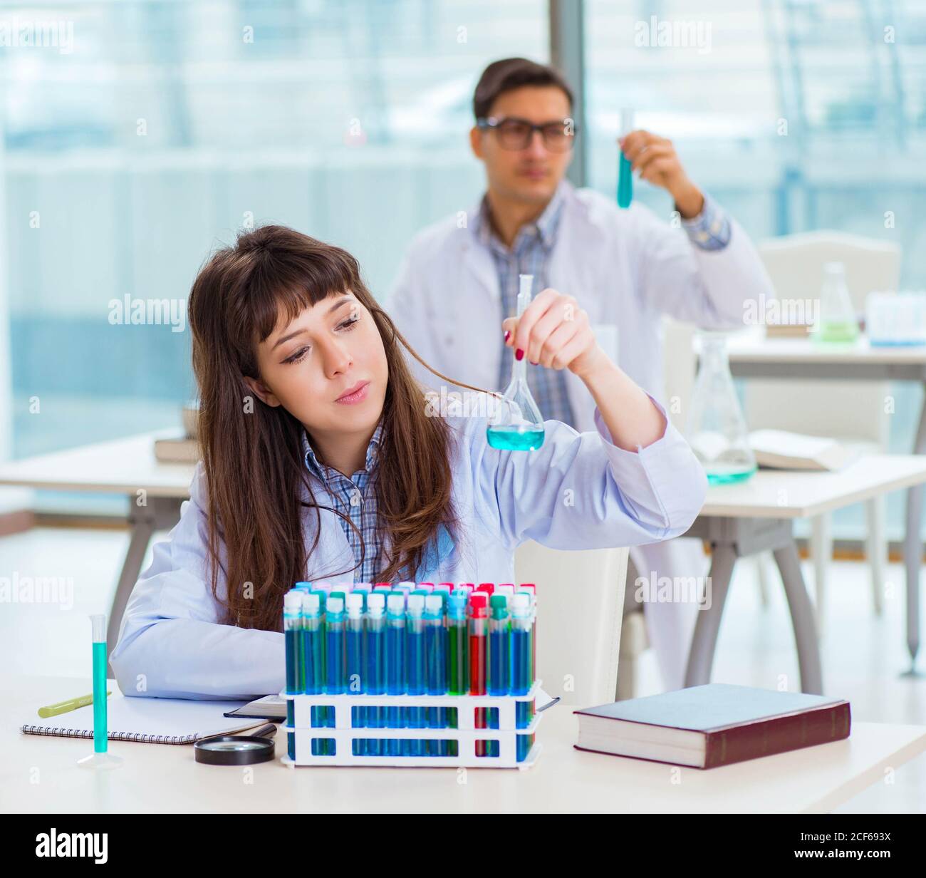 The two chemists working in lab experimenting Stock Photo - Alamy