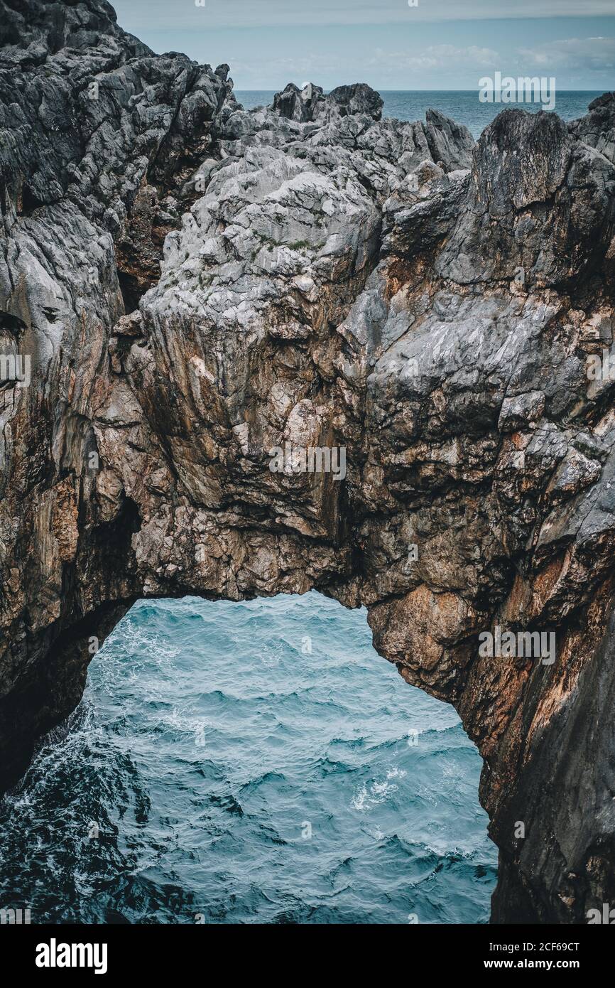 Breathtaking view of rocky cliffs with natural arch and beautiful ...