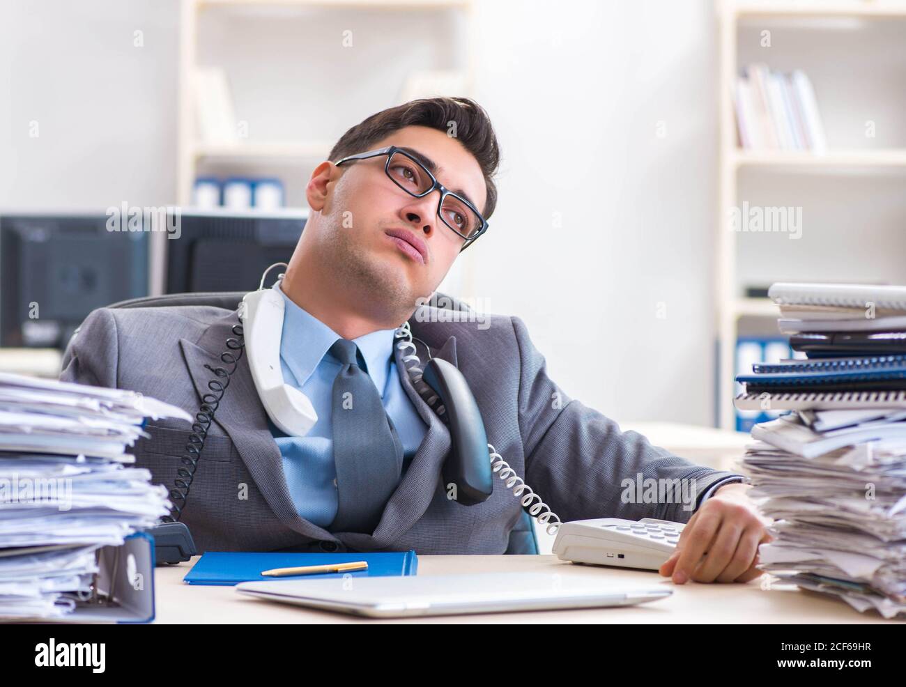 The desperate sad employee tired at his desk in call center Stock Photo ...
