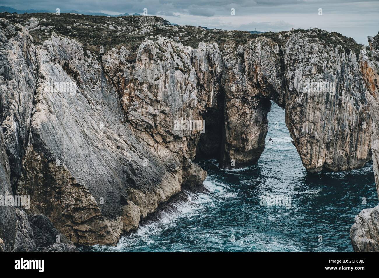 Breathtaking view of rocky cliffs with natural arch and beautiful ...