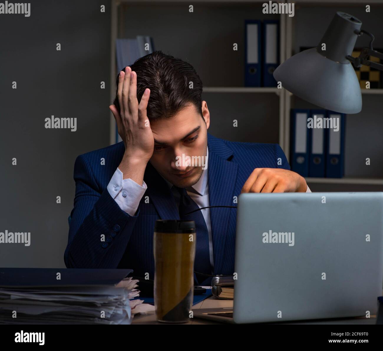 The employee working late to finish important deliverable task Stock ...