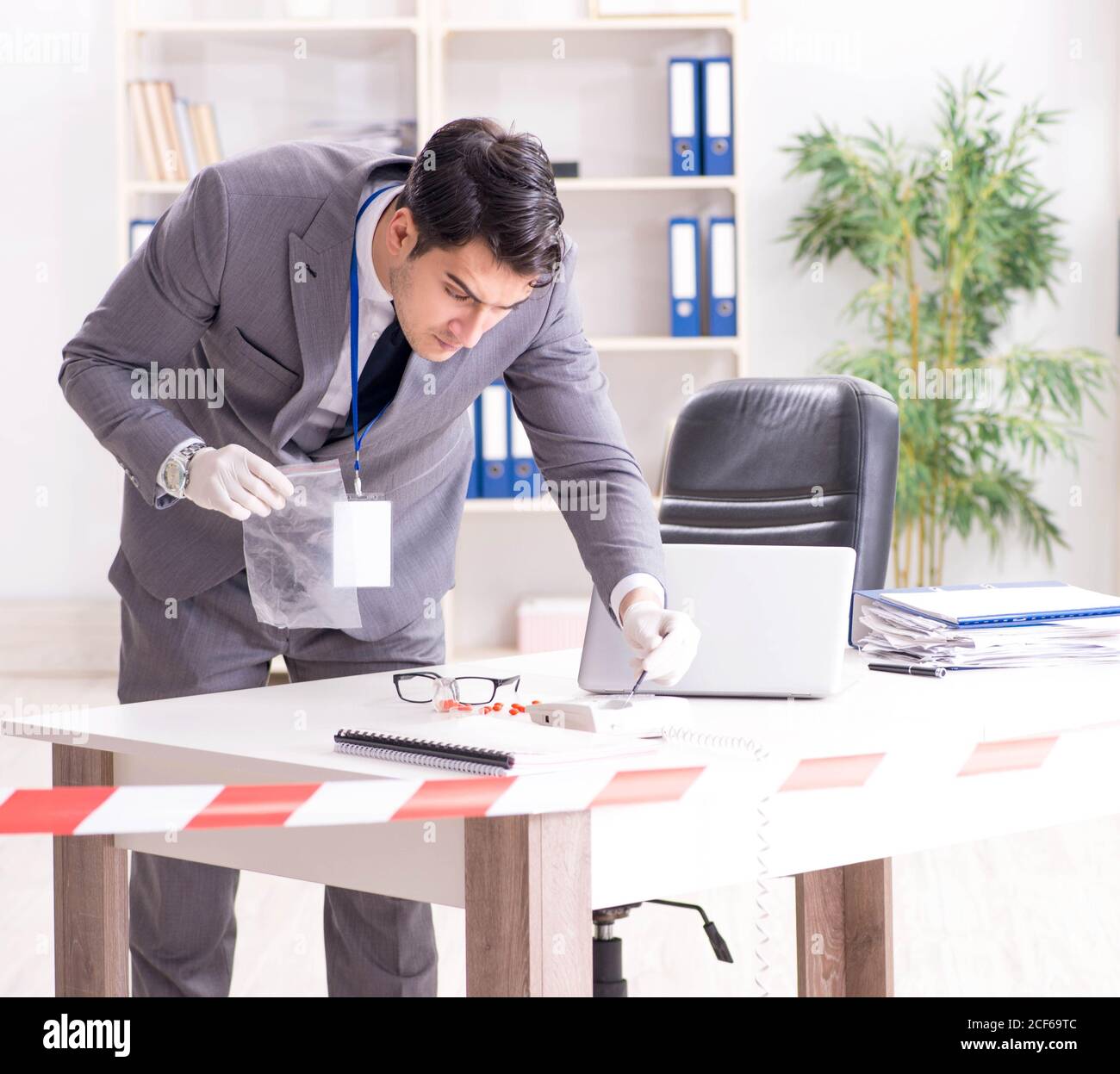 The forensics investigator at the scene of office crime Stock Photo - Alamy