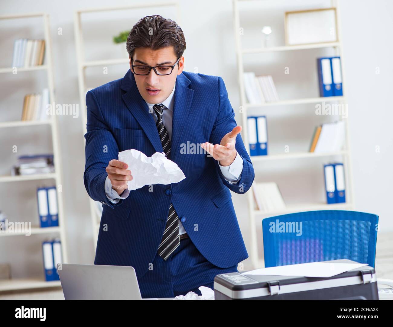 The businessman angry at copying machine jamming papers Stock Photo - Alamy