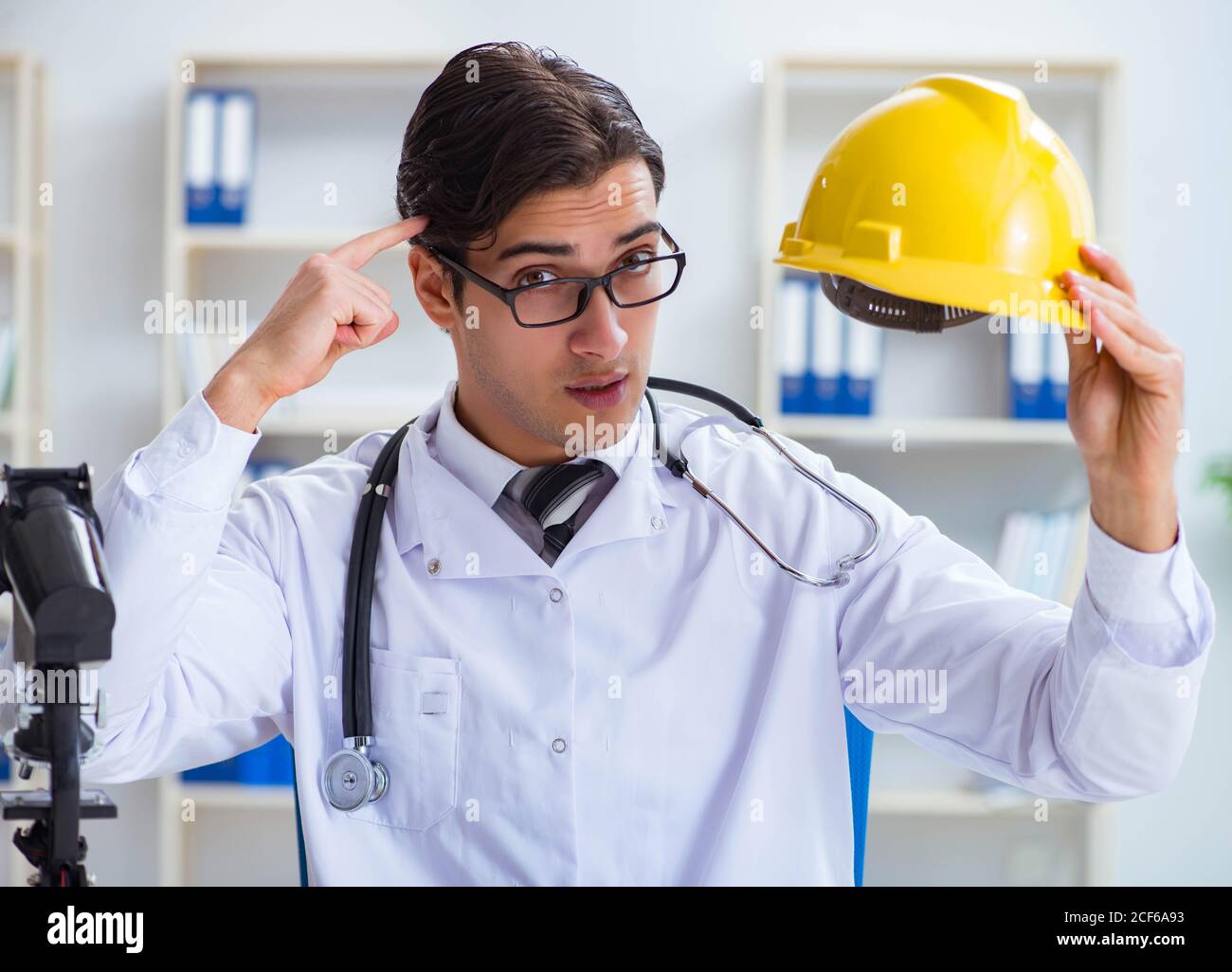 The safety doctor advising about wearing hard hat Stock Photo - Alamy