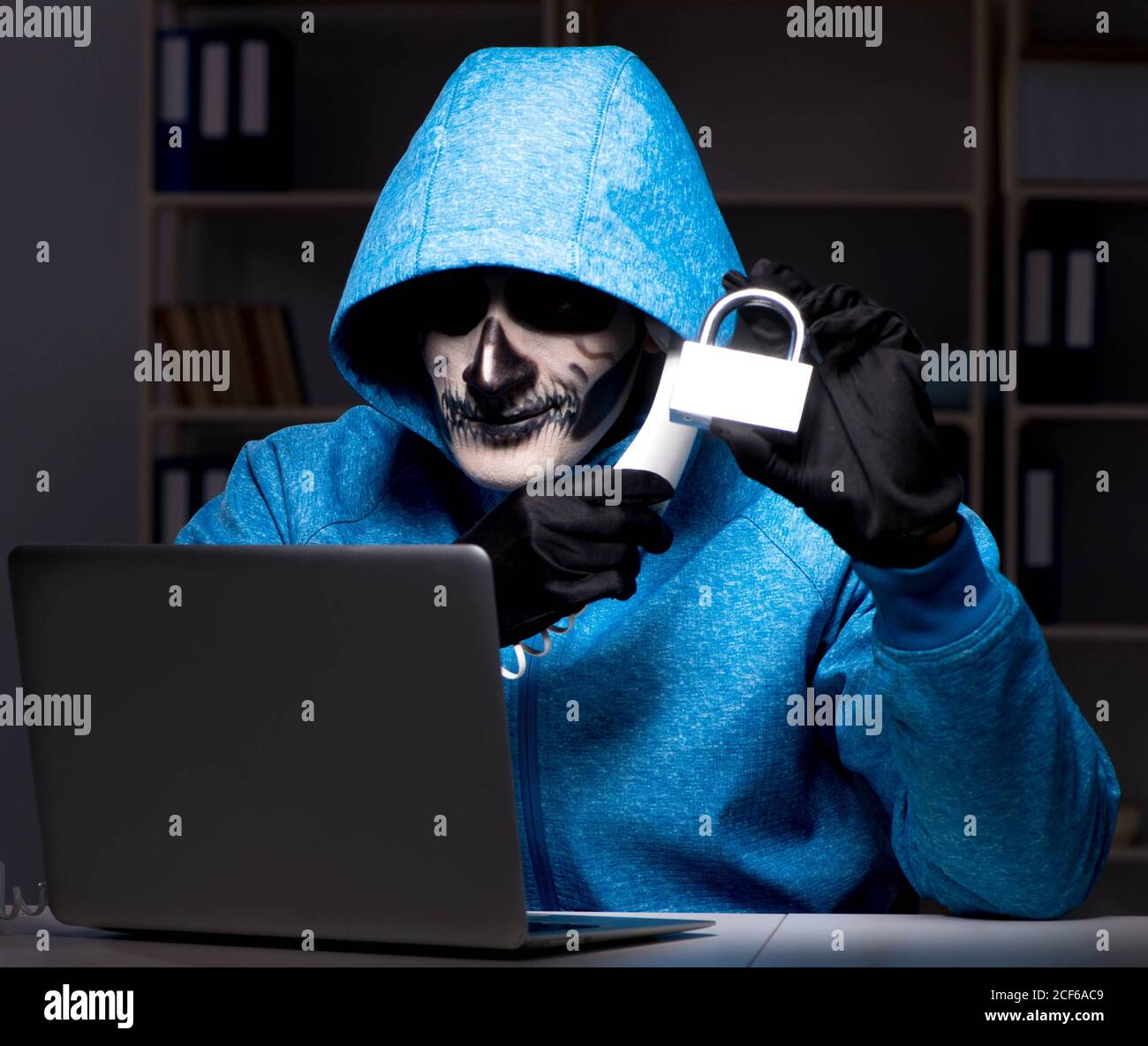 The scary hacker hacking security firewall late in office Stock Photo ...