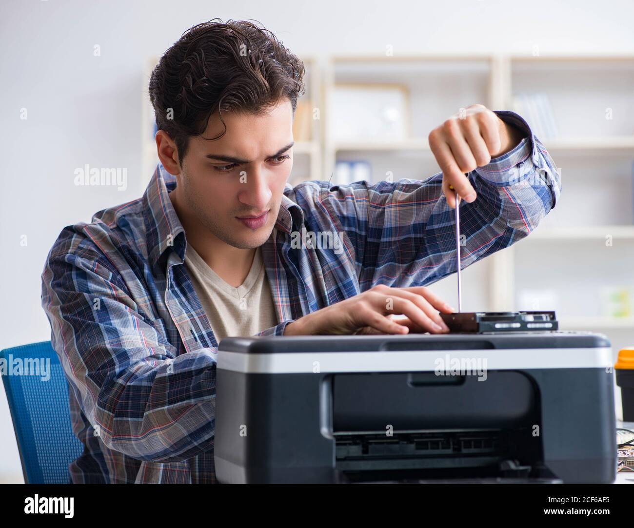 The hardware repairman repairing broken printer fax machine Stock Photo ...