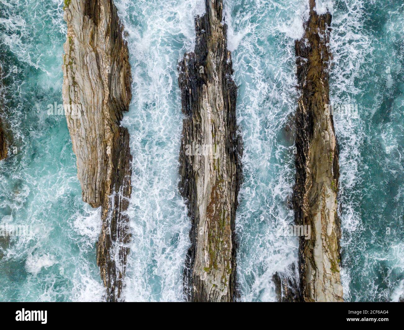 Stone ridges on high seas in stormy day Stock Photo - Alamy
