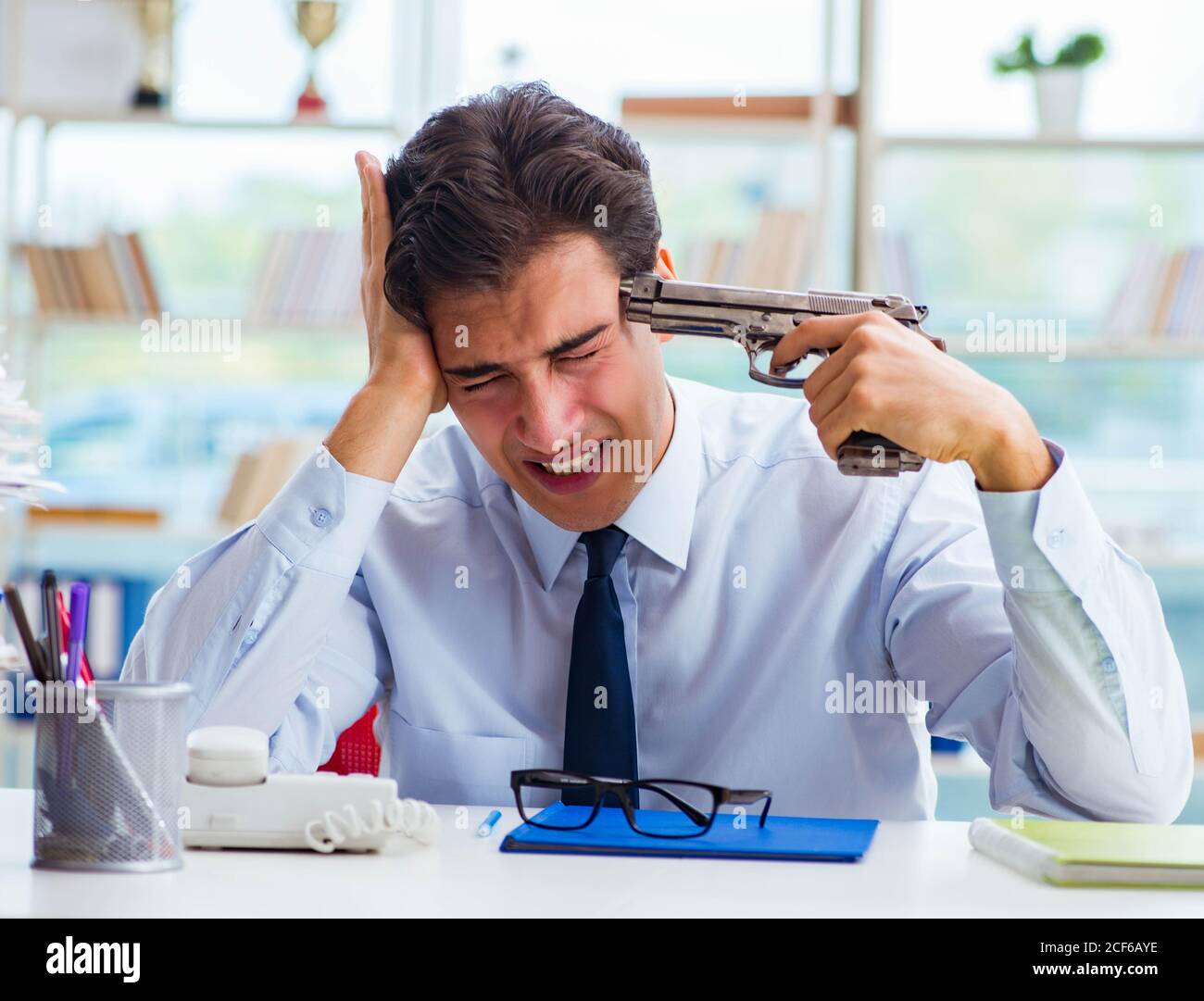 The angry businessman with gun thinking of committing suicide Stock ...