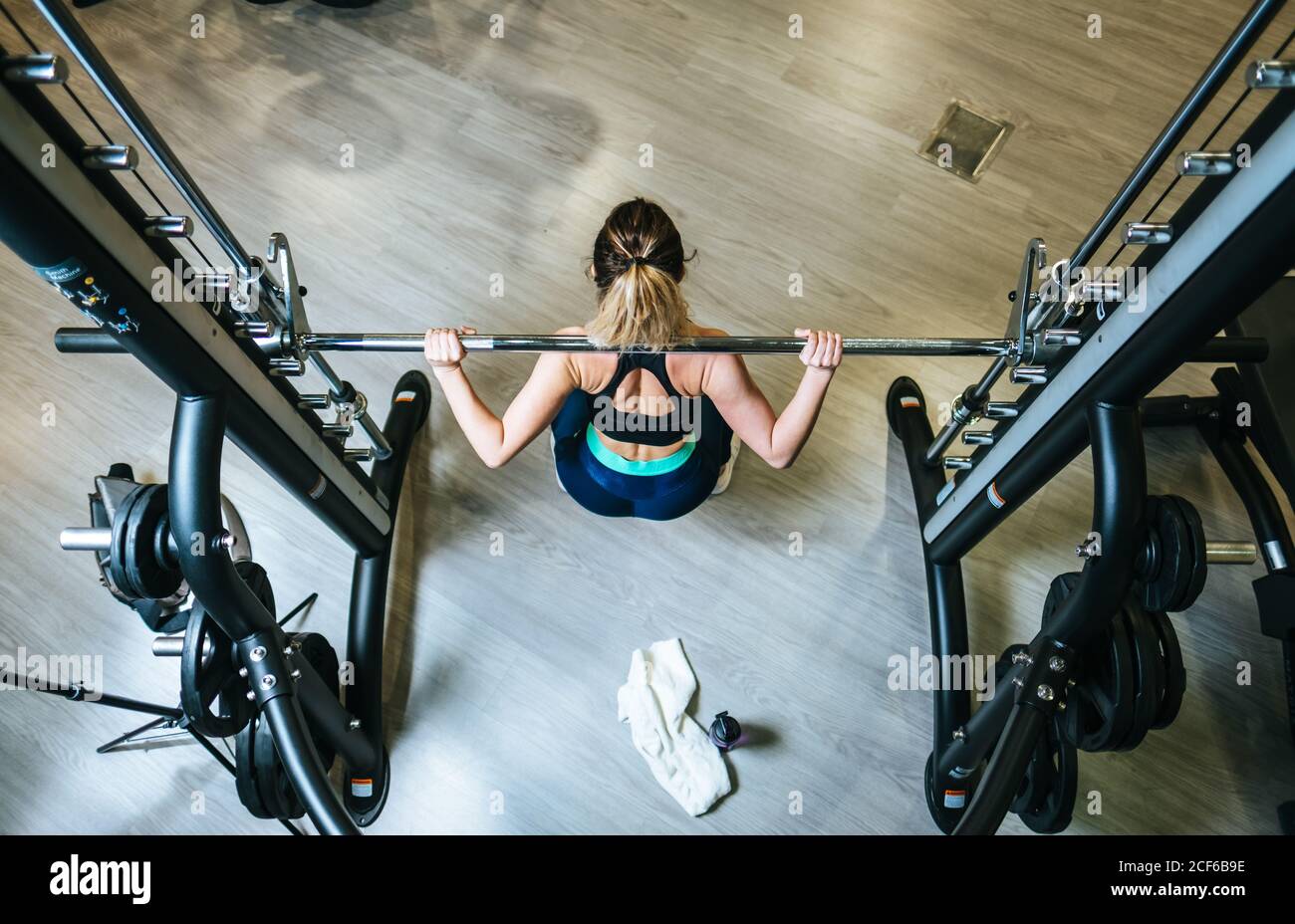 Woman lifting barbell in gym Stock Photo - Alamy