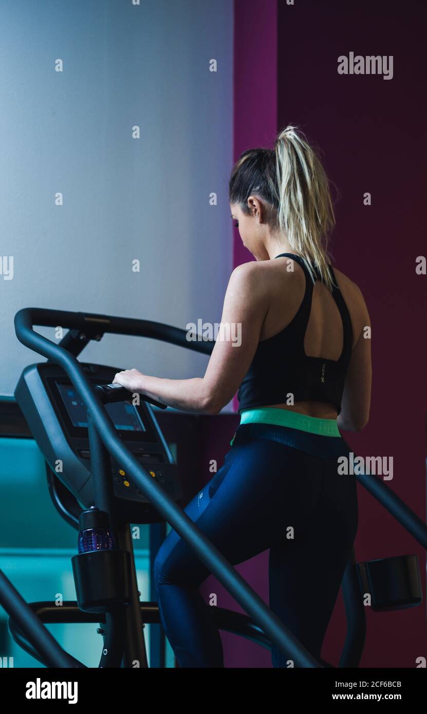 Pretty Woman on exercise machine Stock Photo - Alamy