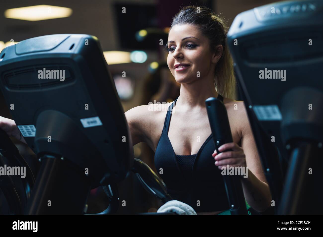 Pretty Woman on exercise machine Stock Photo - Alamy