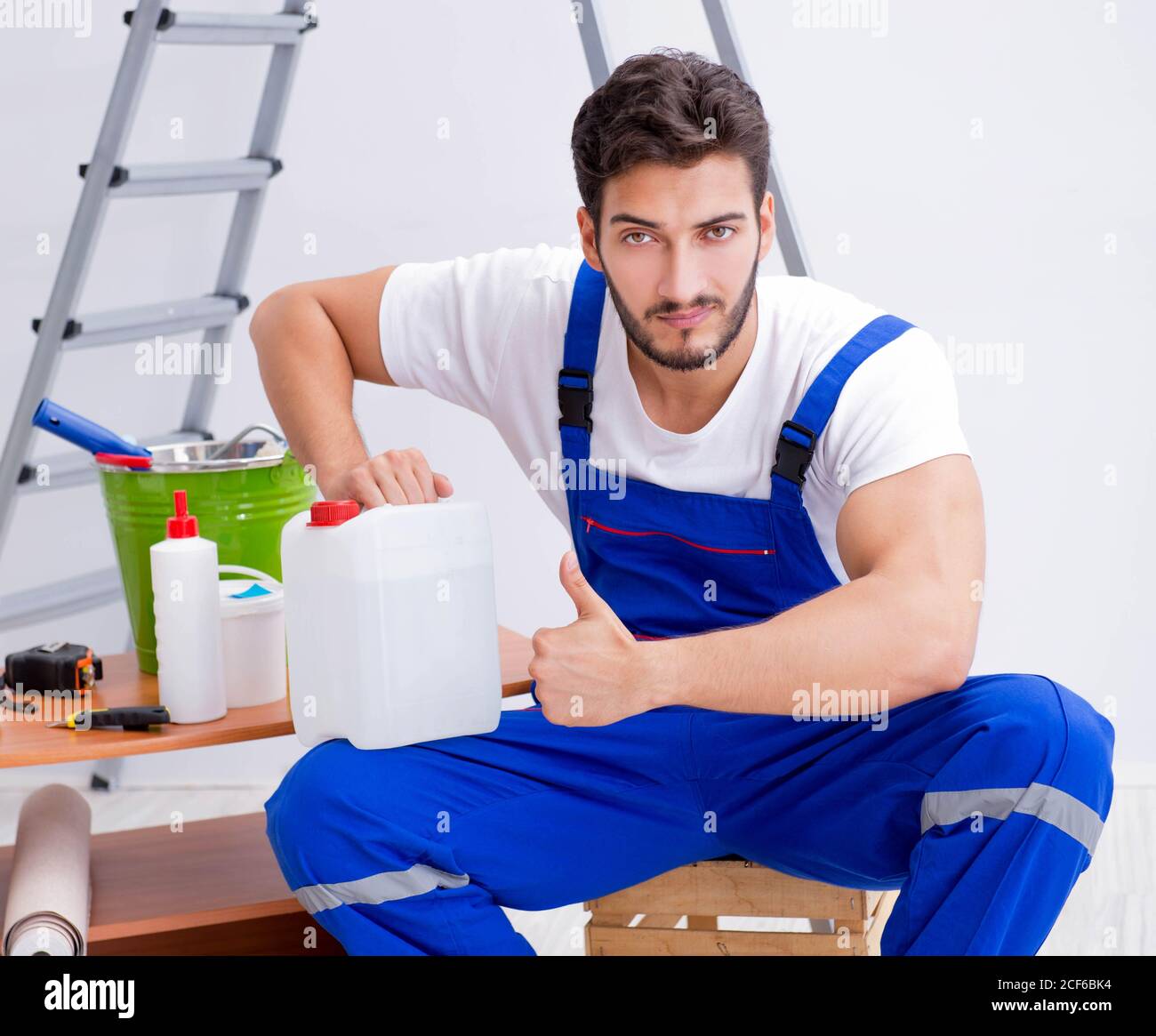 Repairman doing renovation repair in the house with paper wallpaper ...
