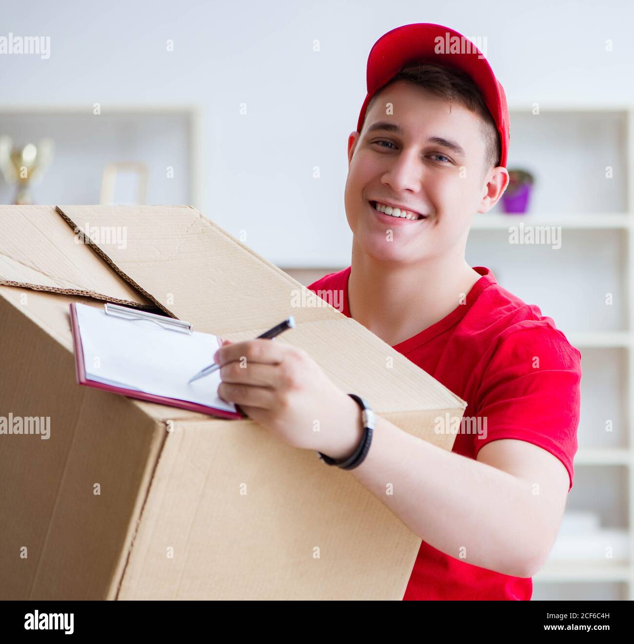 Post man delivering a parcel package Stock Photo - Alamy