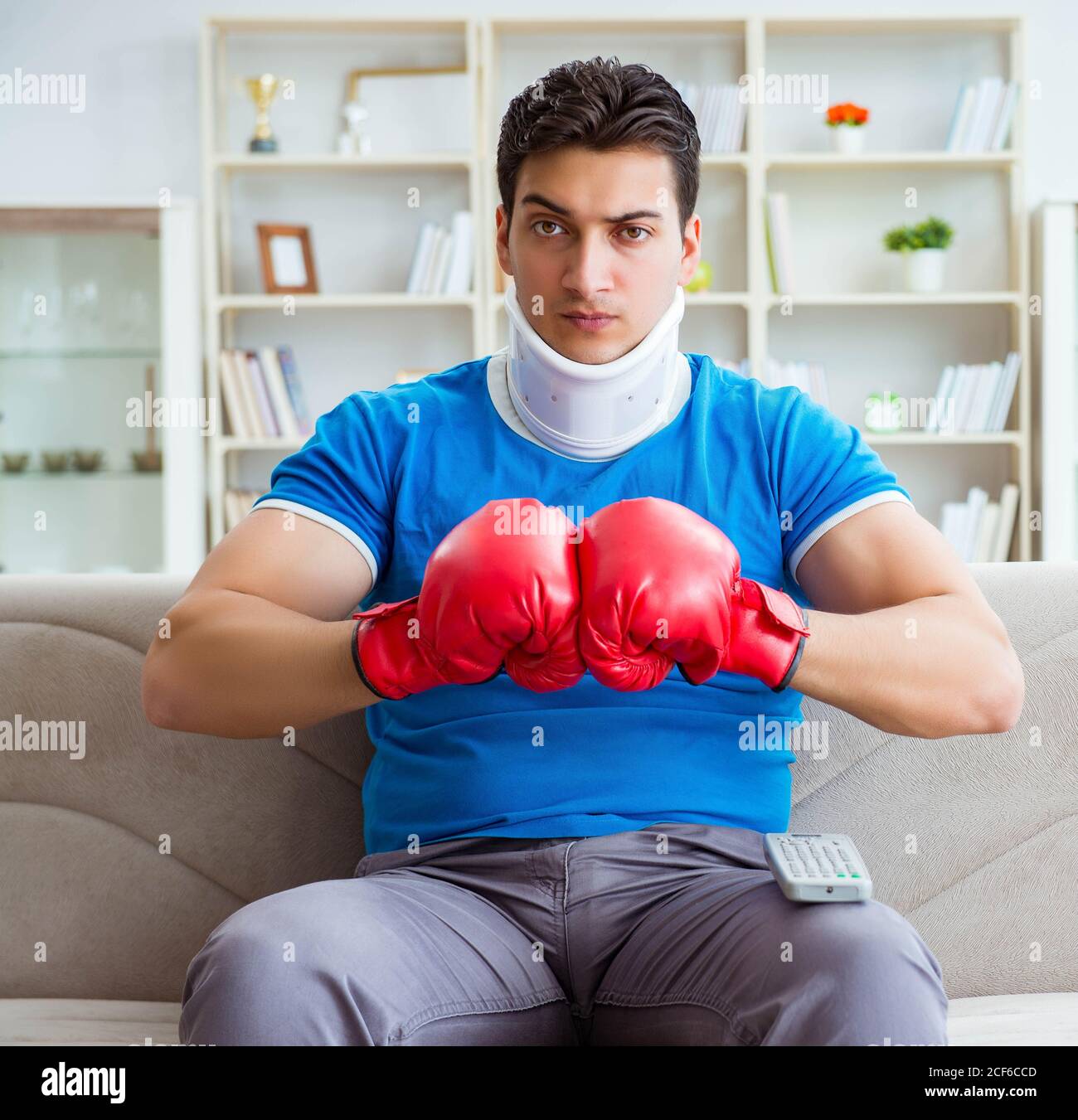 The man with neck injury watching boxing at home Stock Photo - Alamy