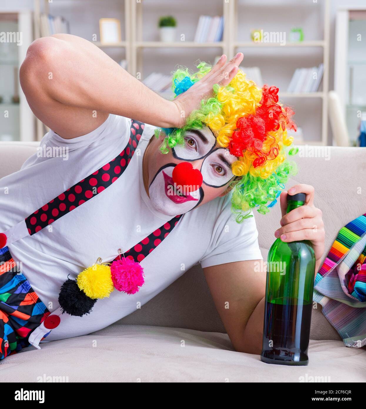 Drunk clown celebrating having a party at home Stock Photo - Alamy
