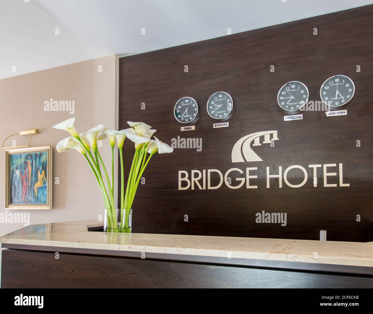 Hotel reception with desk and clocks Stock Photo - Alamy