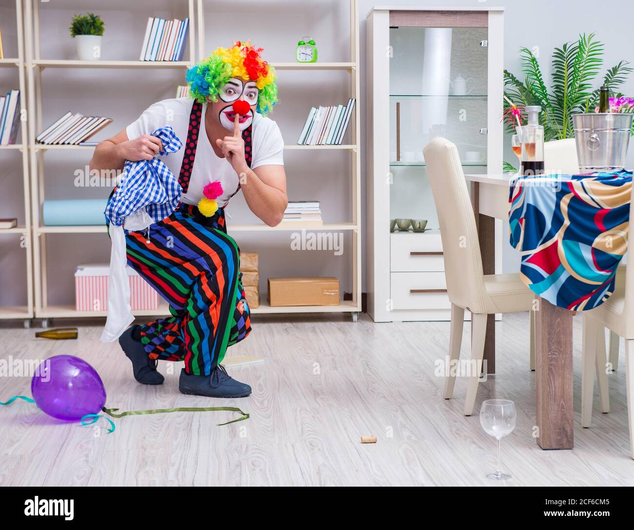 Drunk clown celebrating having a party at home Stock Photo - Alamy