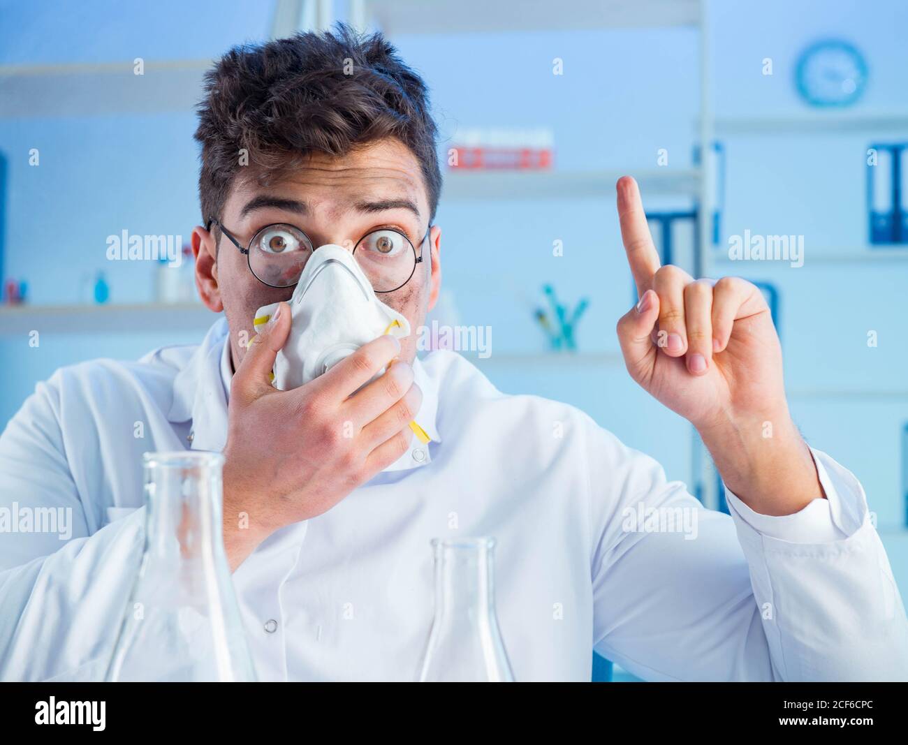 Funny mad chemist working in a laboratory Stock Photo - Alamy